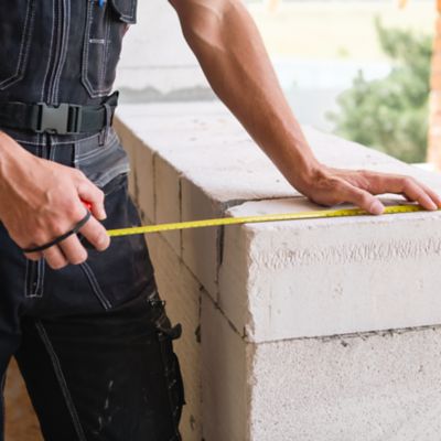 Capping an interlocking block retaining wall